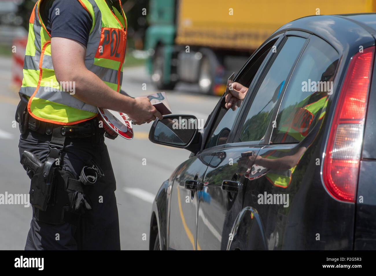 15 June 2018, Germany, Pocking: A German police officer checks a ...