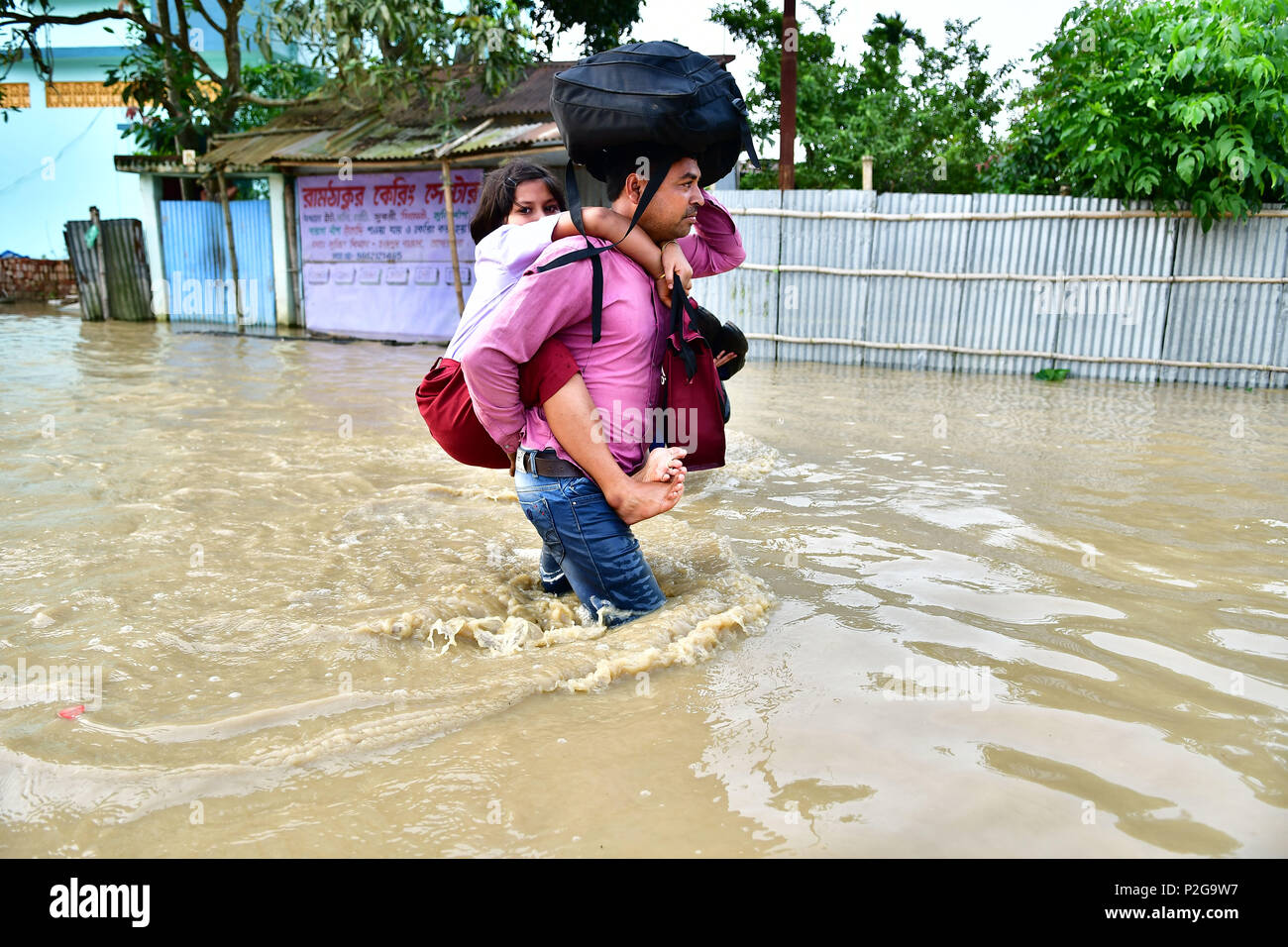 Agartala, India. 15th Jun, 2018. A man carrying a young girl on his ...