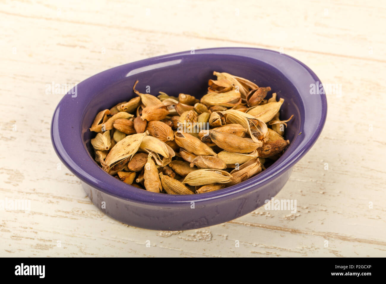 Dry cardamom seeds heap in the bowl Stock Photo - Alamy