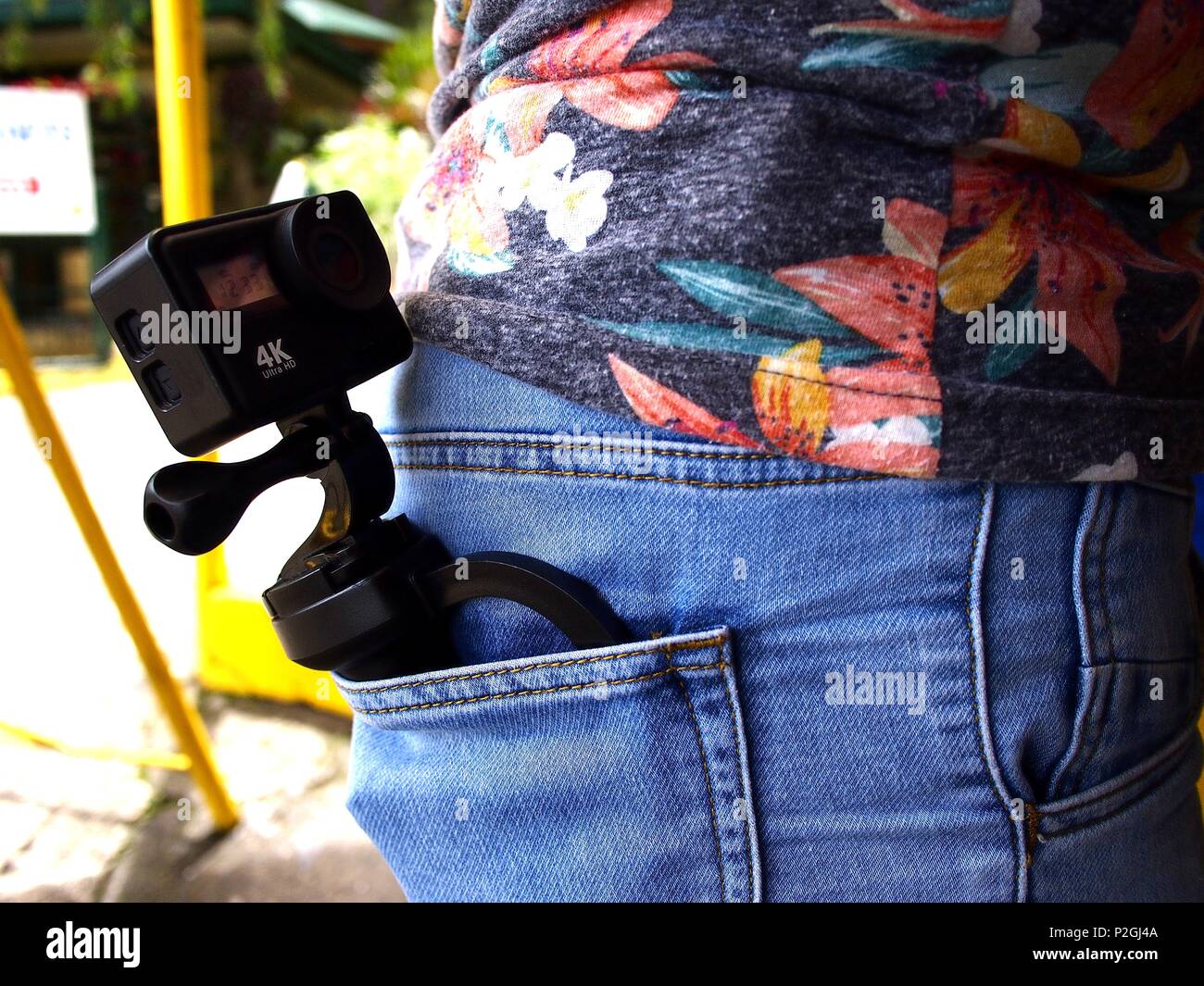 Photo of an action camera in the back pocket of a person's denim jeans ...