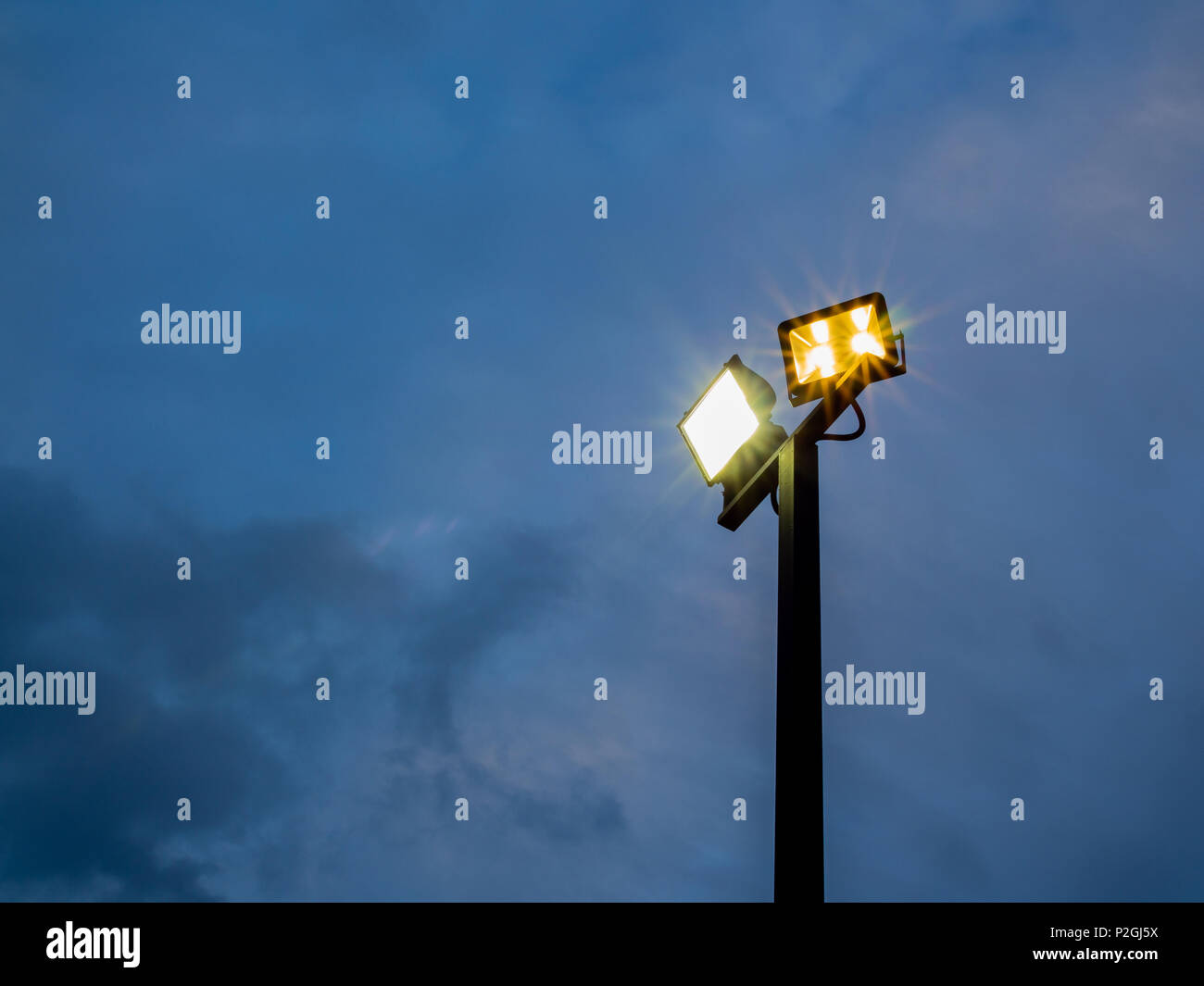 Spotlight Standing Tall on Dark Blue Sky Background Stock Photo - Alamy