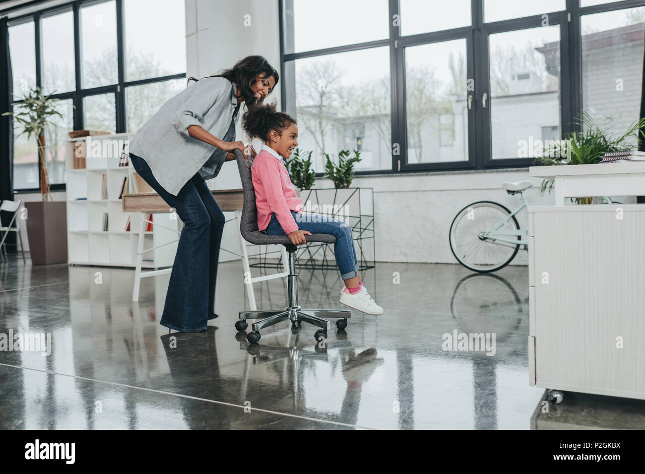 businesswoman playing with happy daughter in business office, work and ...