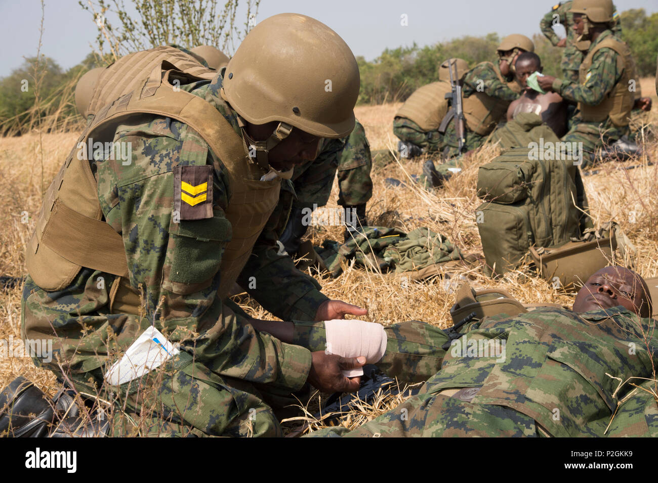 A Rwanda Defense Force Soldier applies a bandage to a simulated-wounded ...