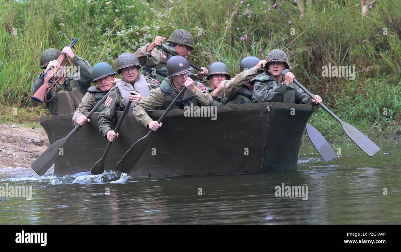 Volunteers participate paddle a canvas boat during the 307th Brigade ...