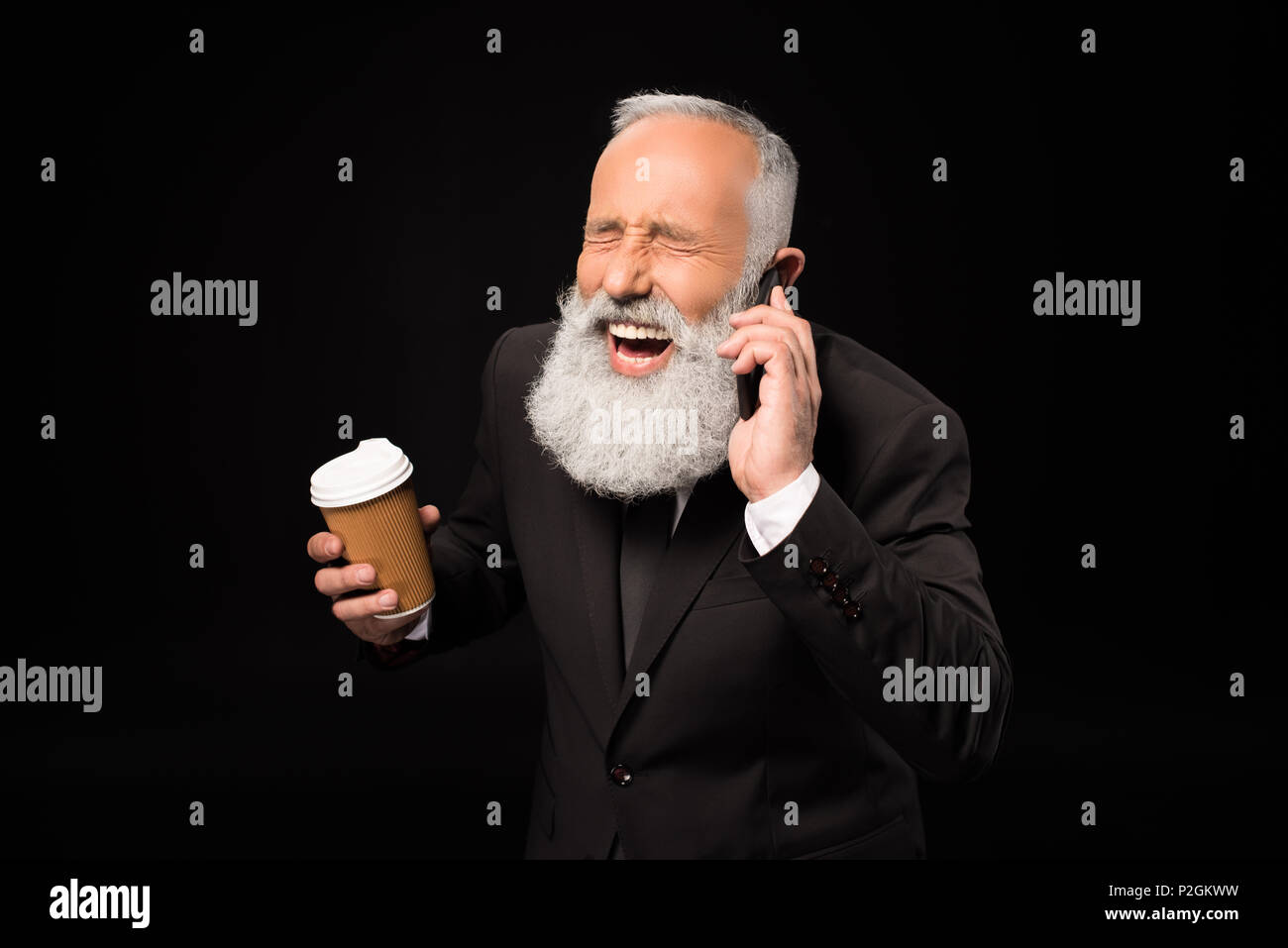 Half-length shot of businessman in a suit laughing with his eyes closed ...