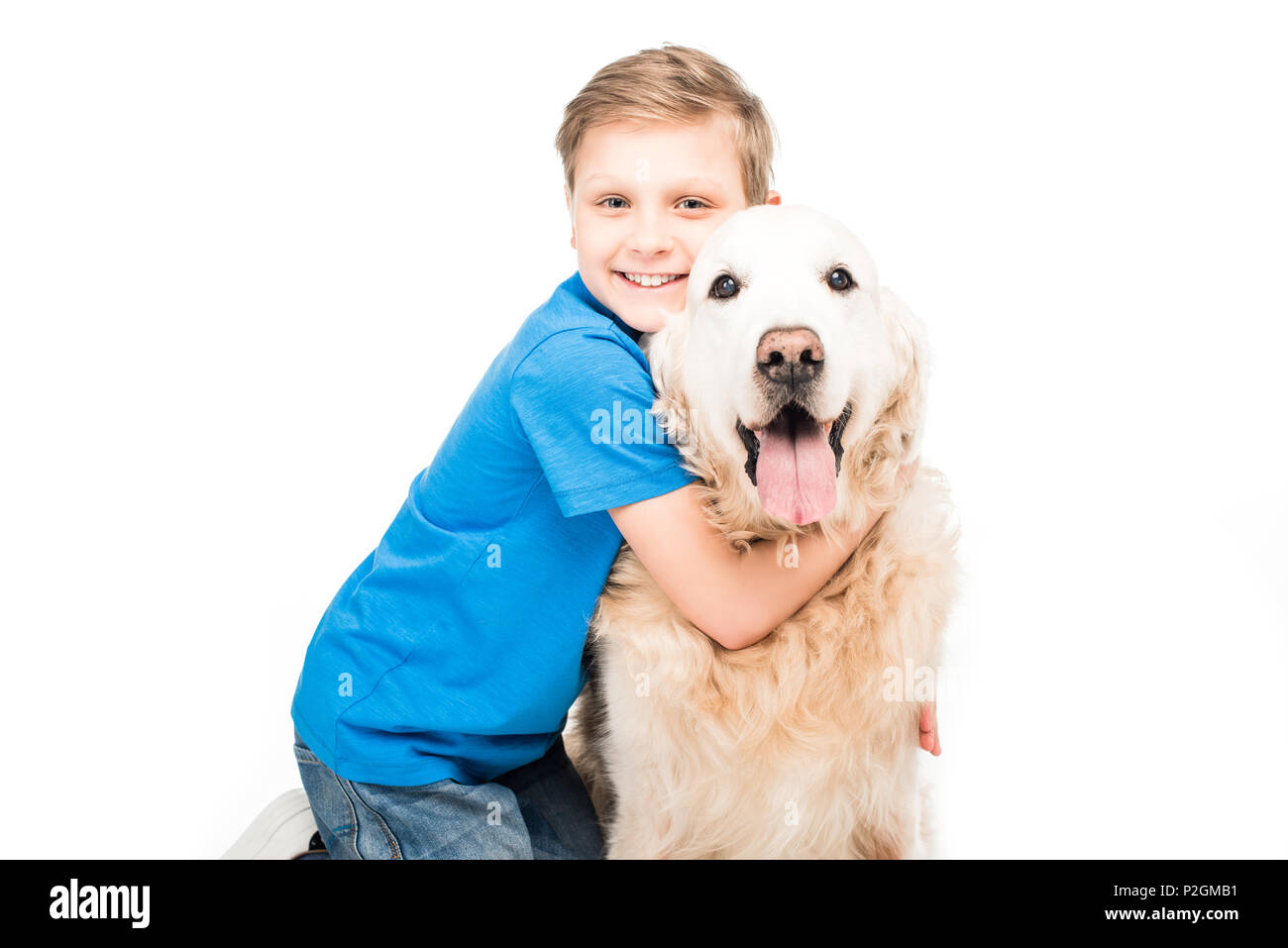 cute little boy hugging dog and smiling at camera isolated on white ...