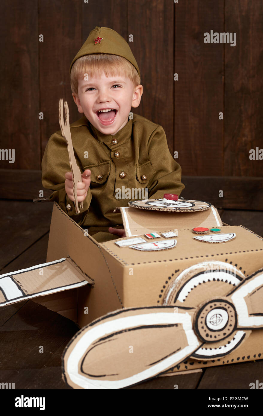 children boy are dressed as soldier in retro military uniforms repair ...