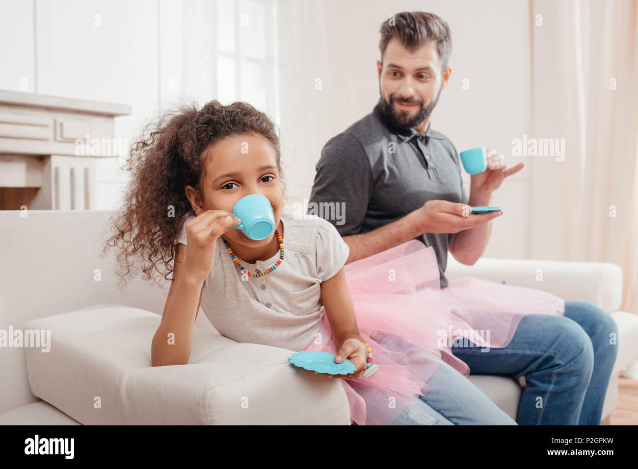 multicultural family drinking tea while having tea party at home Stock ...