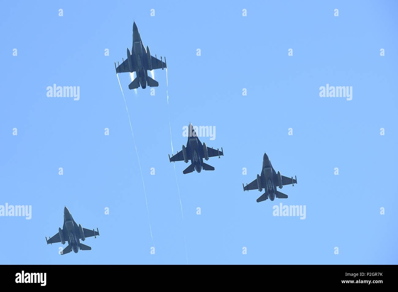Four F-16 Fighting Falcons fly in a missing man formation over the ...