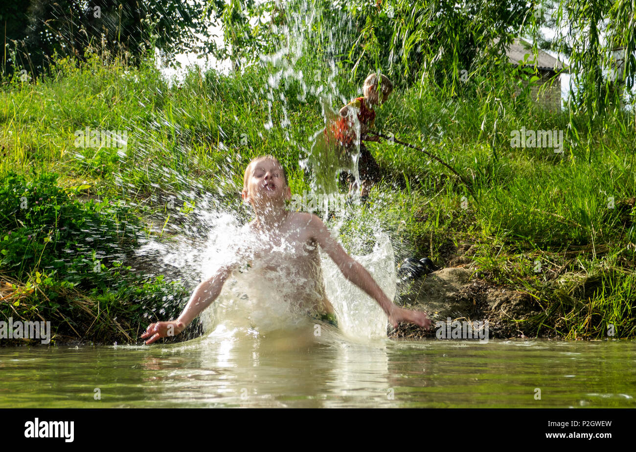 Boy jumping into pond hi-res stock photography and images - Alamy
