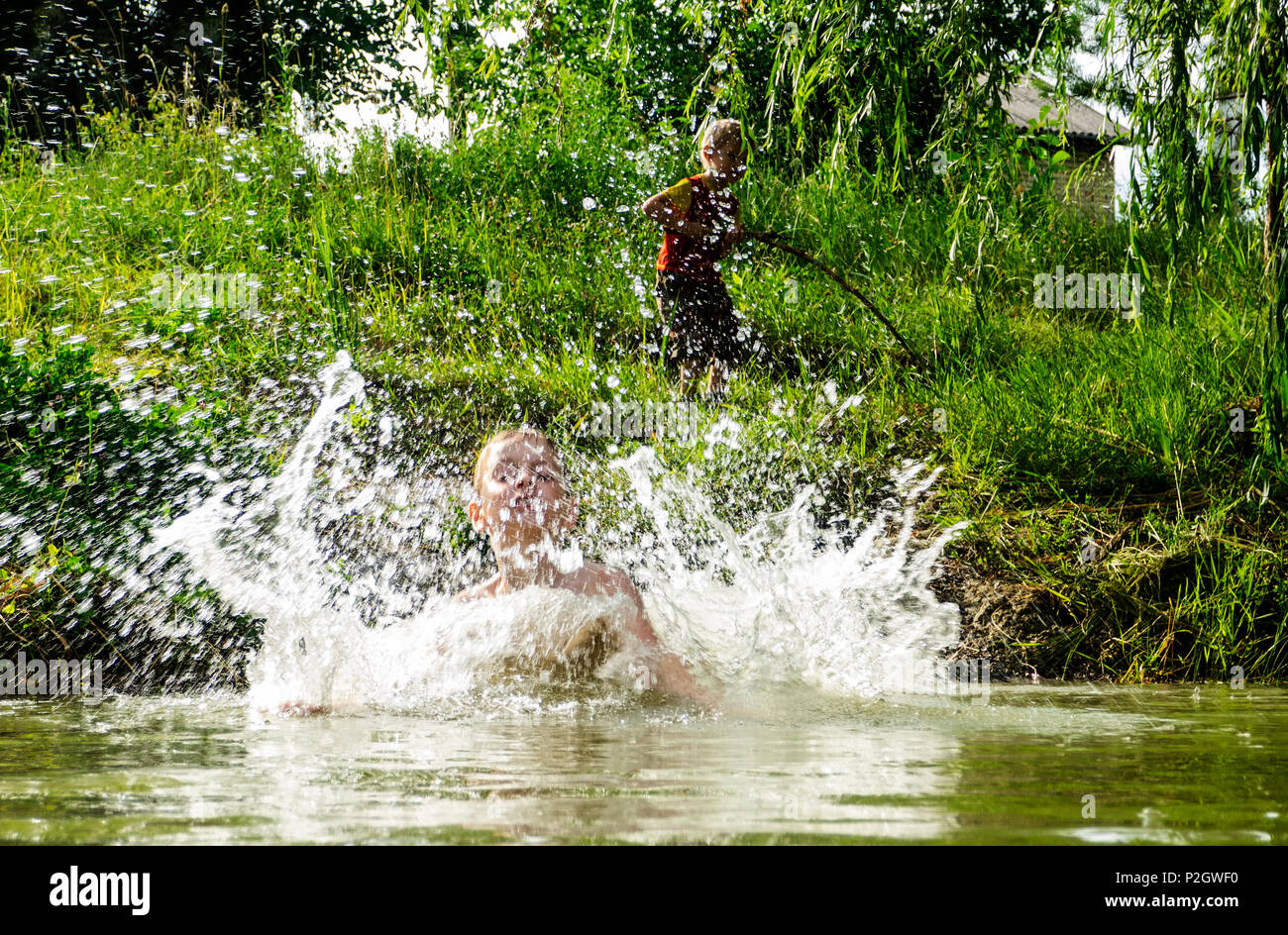 Boy jumping into pond hi-res stock photography and images - Alamy