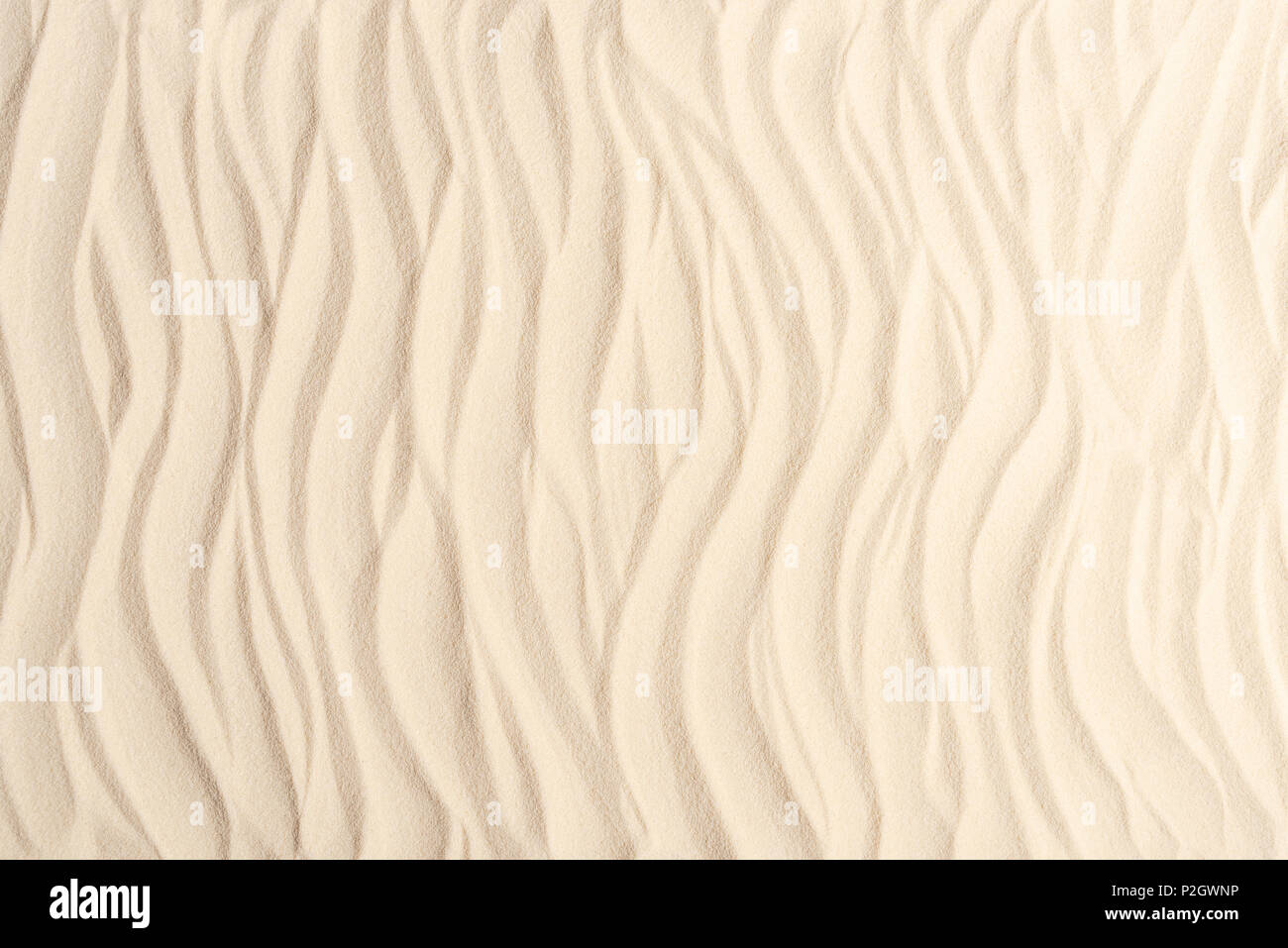 Smooth wind waves on light sand Stock Photo - Alamy