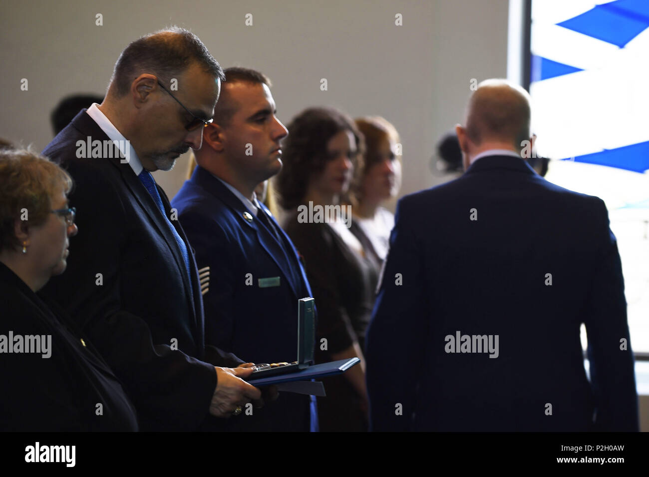 Keith Less, father of U.S. Air Force Staff Sgt. Janna Less, looks down ...
