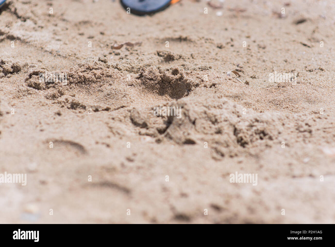 Background photo with beach sand in front of sea water Stock Photo - Alamy