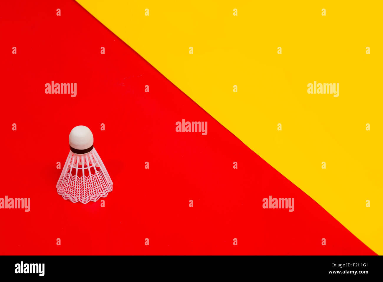 Badminton shuttlecock against a red and yellow background Stock Photo ...