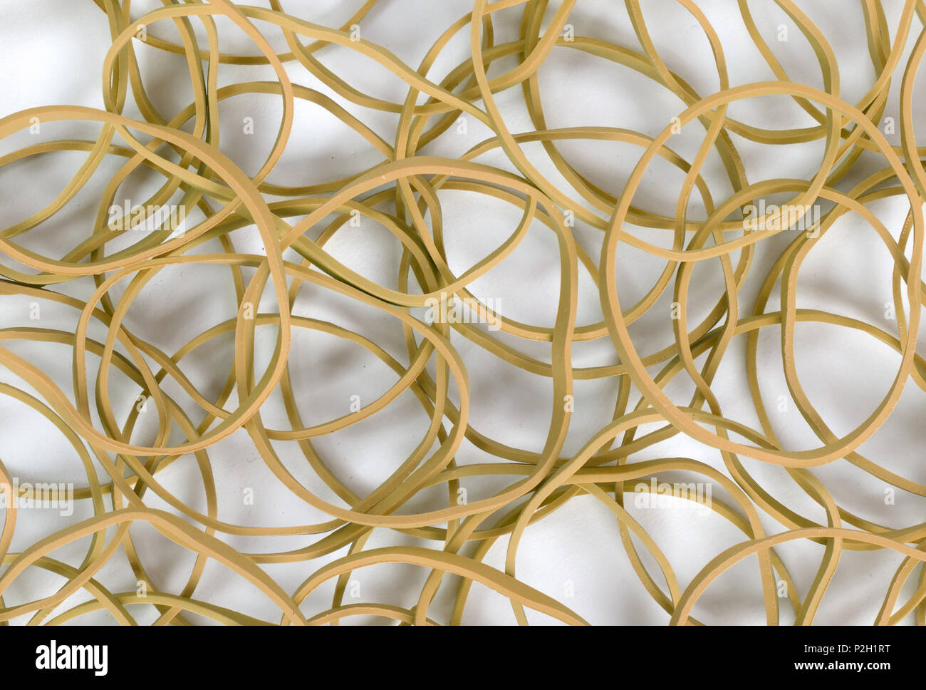 Close view small rubber bands on a white background Stock Photo - Alamy