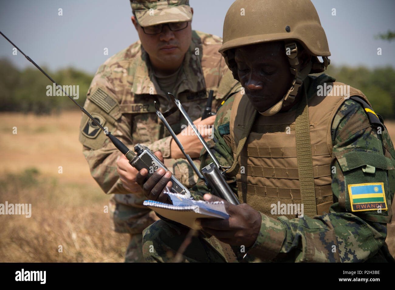 A Rwanda Defense Force soldier calls in a 9-line report to request a ...