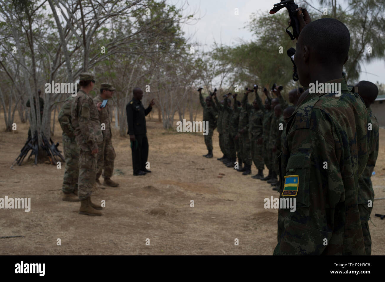 Rwanda Defense Force soldiers hold up tourniquets before self-applying ...