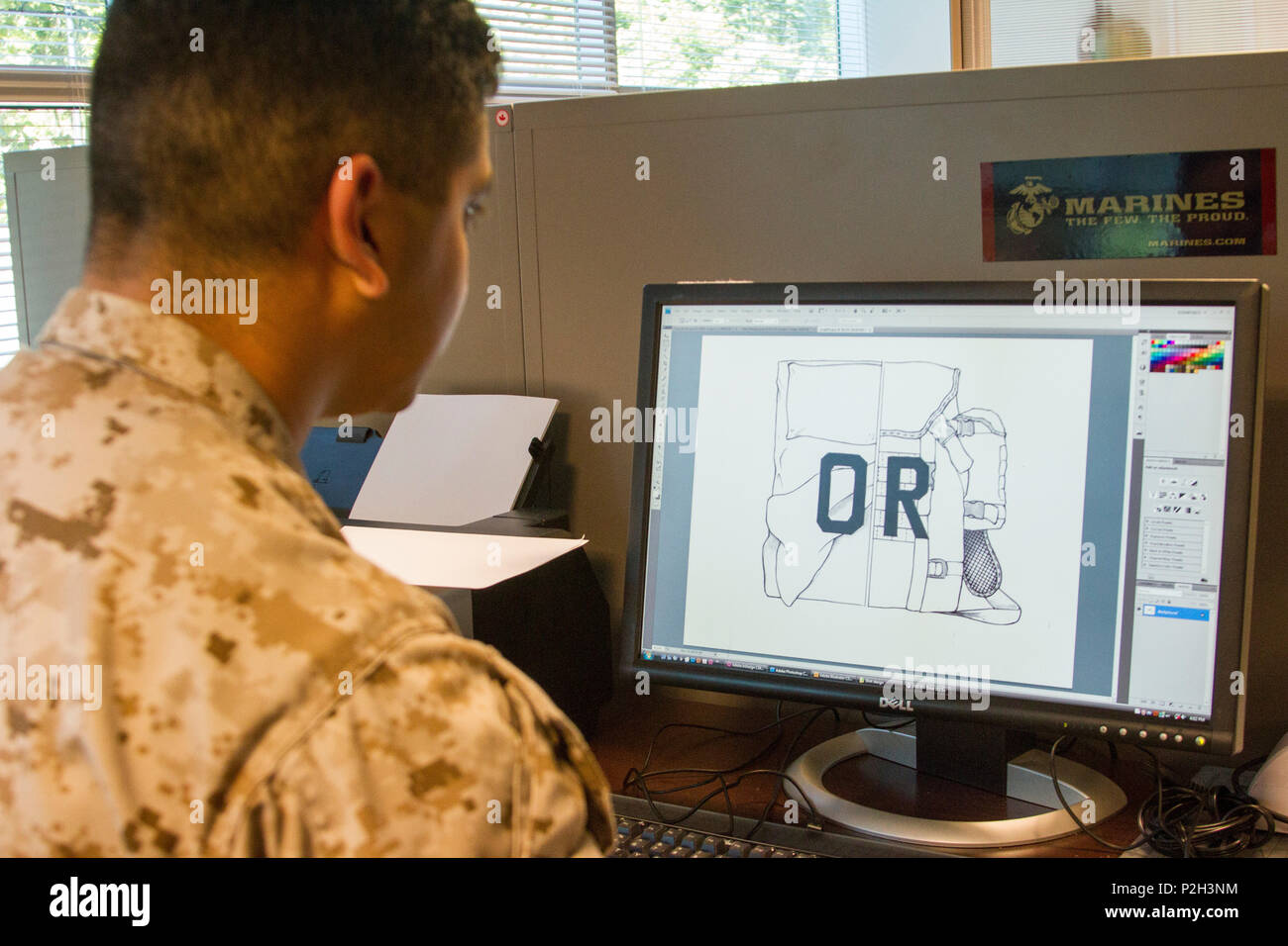 Sgt. John A. Martinez reviews the design he submitted for a ‘military ...