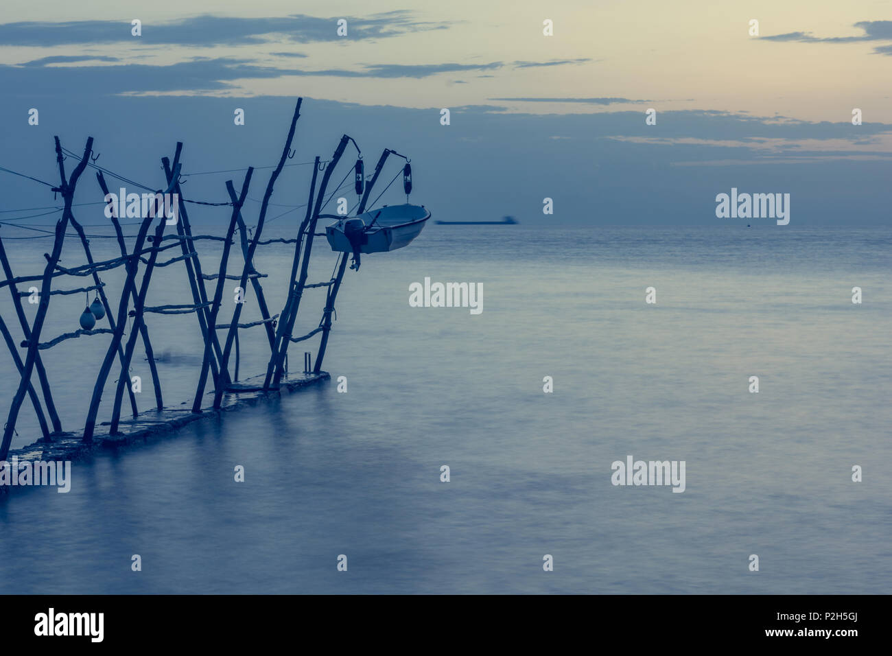 Fishing boat hanging from the poles at sunset. Seascape panorama Stock ...