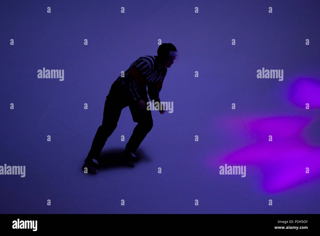 Referee silhouette is judging a match on ice hockey Stock Photo - Alamy