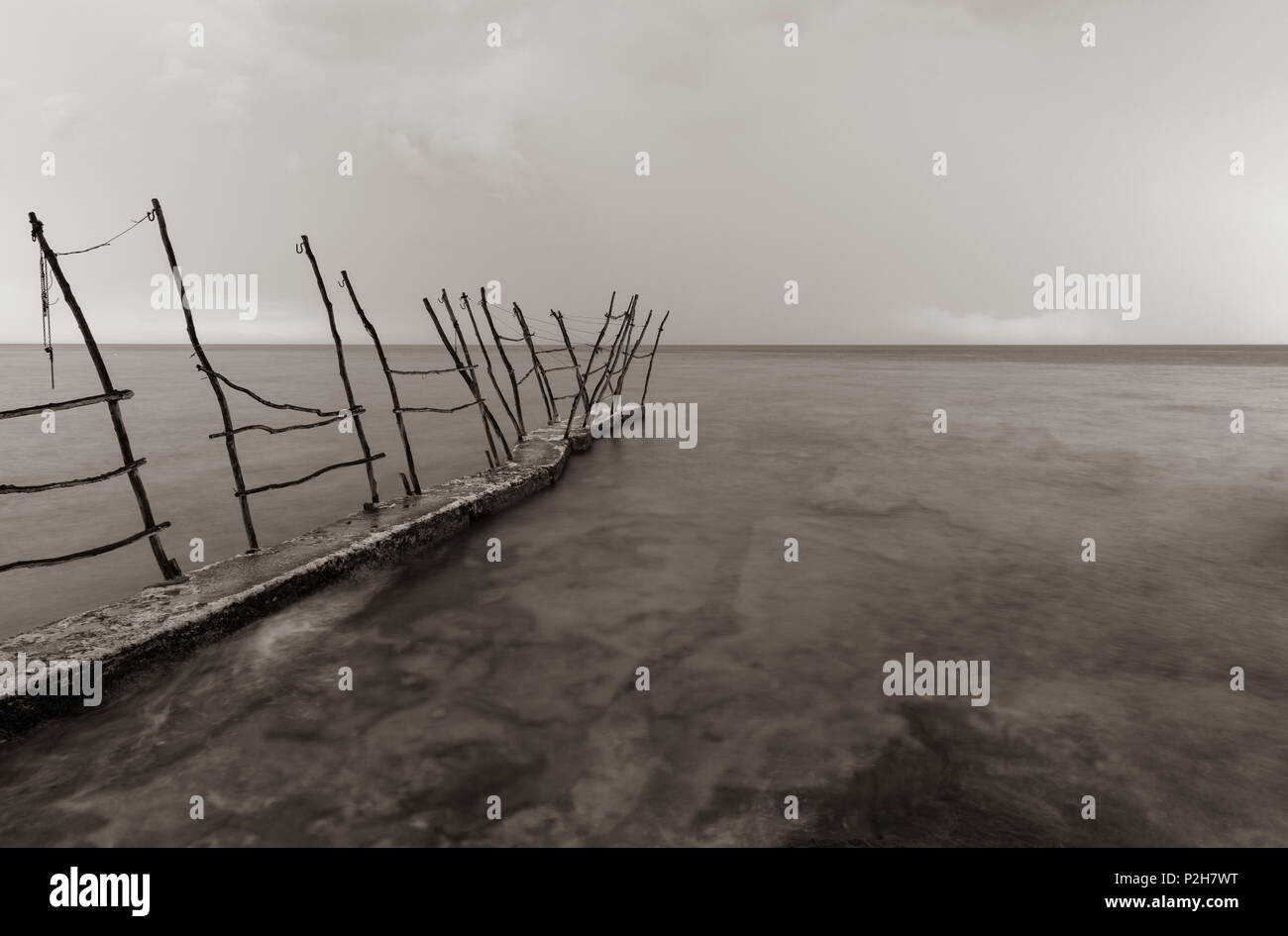 Overcast ocean view with long exposure technique. Traditional wooden ...