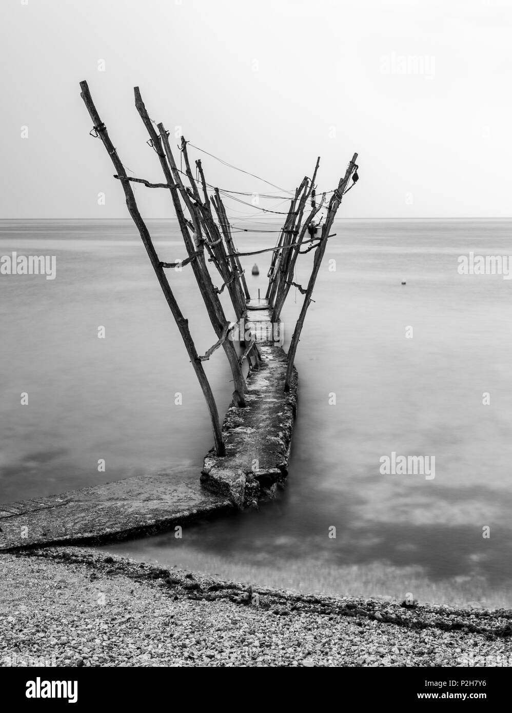 Overcast ocean view with long exposure technique. Traditional wooden ...