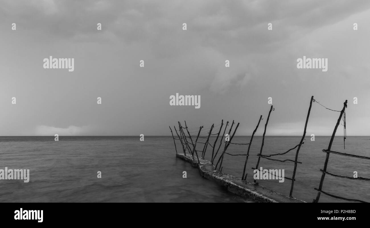 Overcast ocean view with long exposure technique. Traditional wooden ...