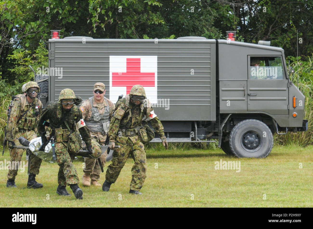 Japan Ground Self-Defense Force medics carry a casualty from an ...