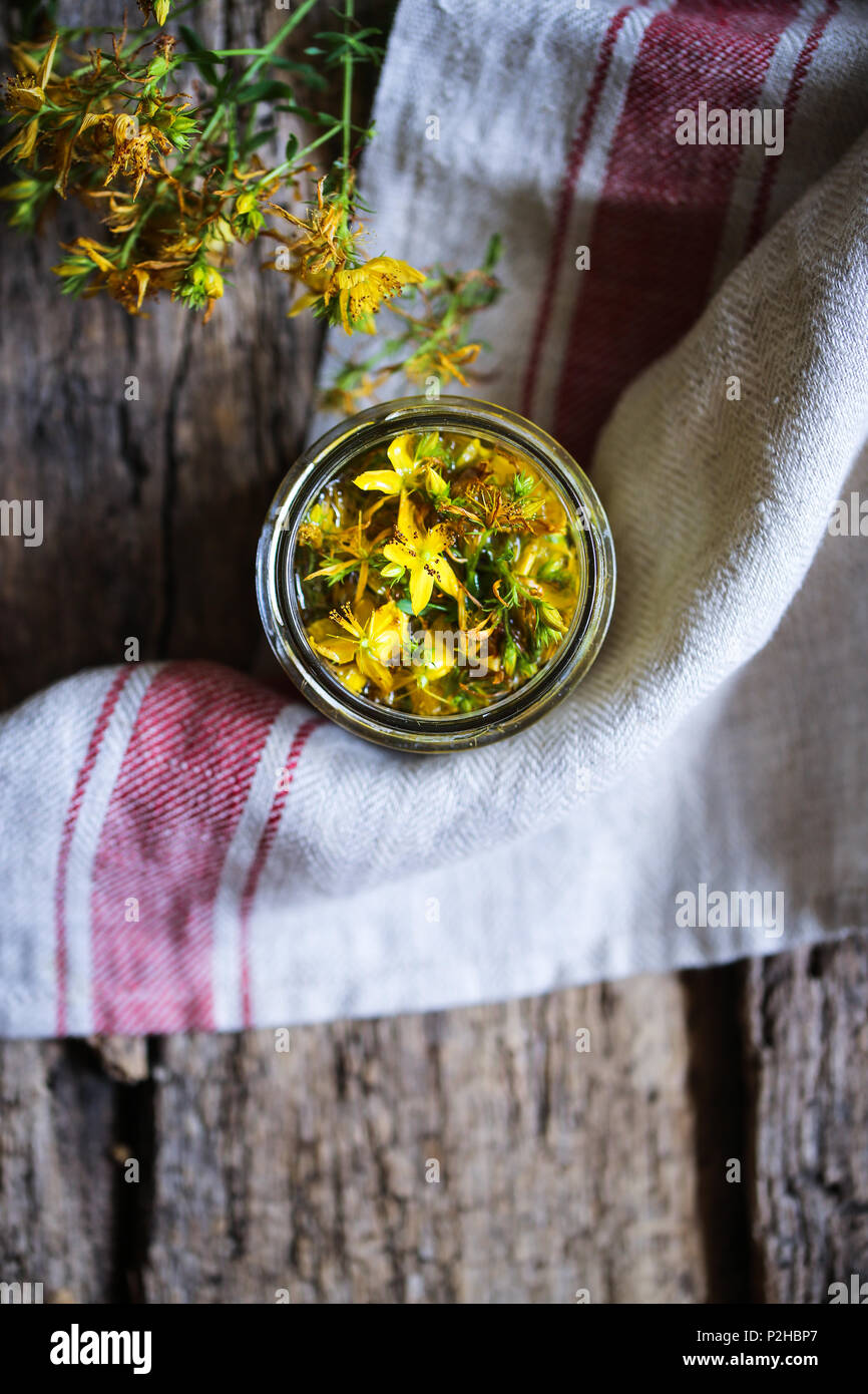 Hypericum flowers in maceration under oil Stock Photo - Alamy