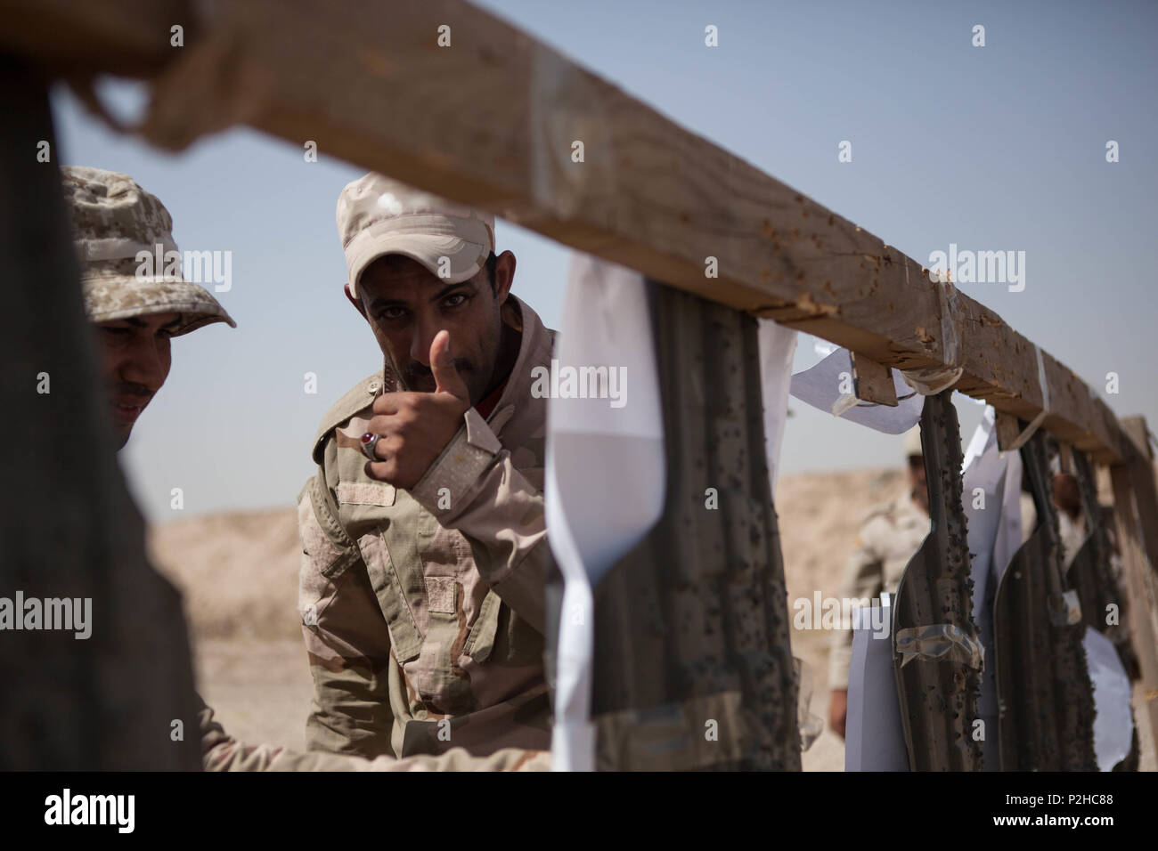 An Iraqi soldier gives a thumbs-up after reviewing his target at the ...