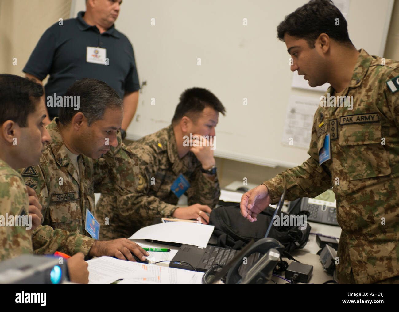 Members of the Pakistan Army discuss a training scenario during ...