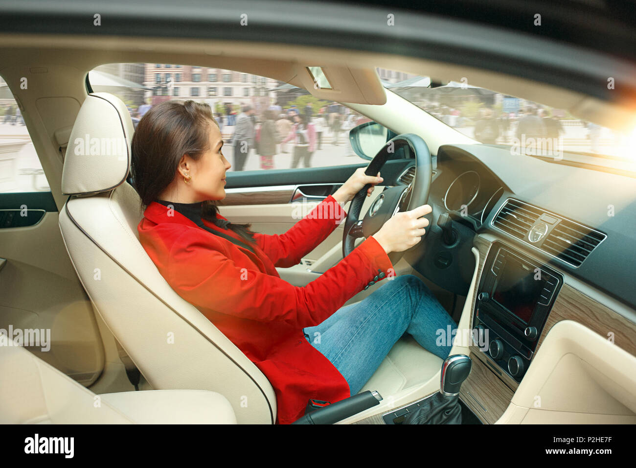 Driving around city. Young attractive woman driving a car Stock Photo ...