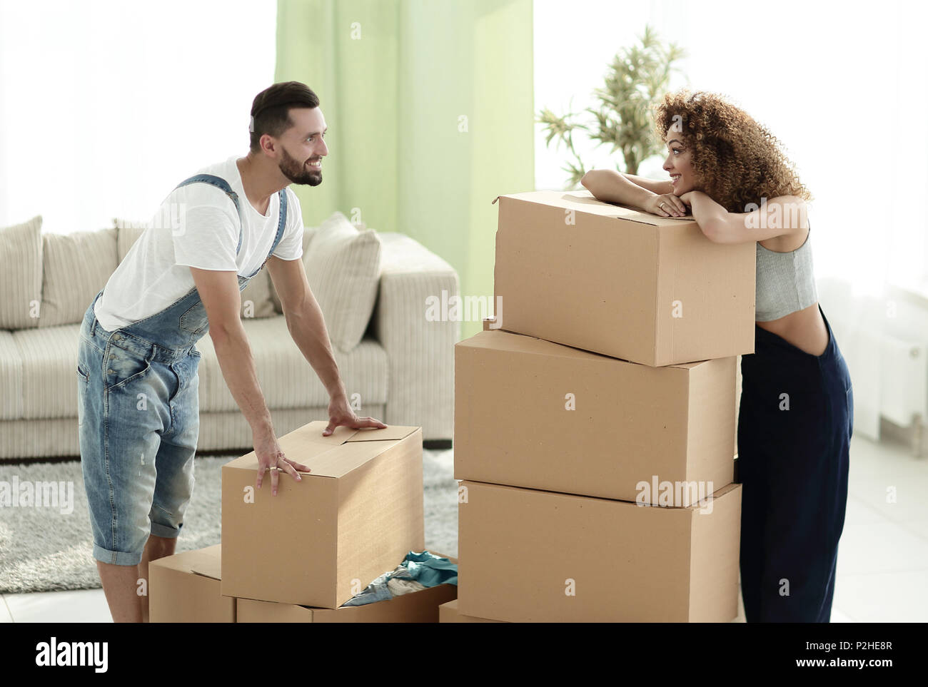Happy and young couple looking at boxes Stock Photo - Alamy