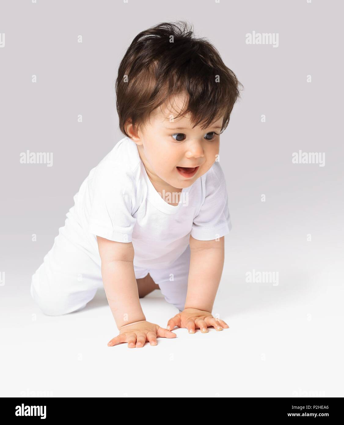 Happy crawling baby. Side view Stock Photo - Alamy