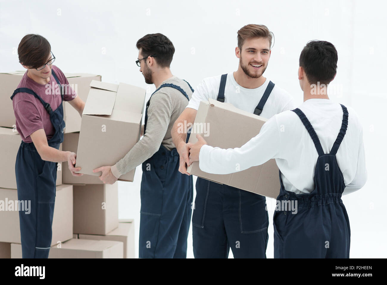 Movers lifting stack of cardboard moving boxes isolated on white Stock ...