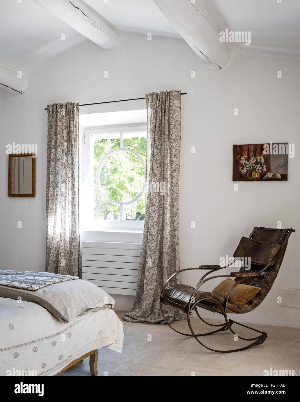 Vinatg leather rocking chair beside window in renovated 18th century ...