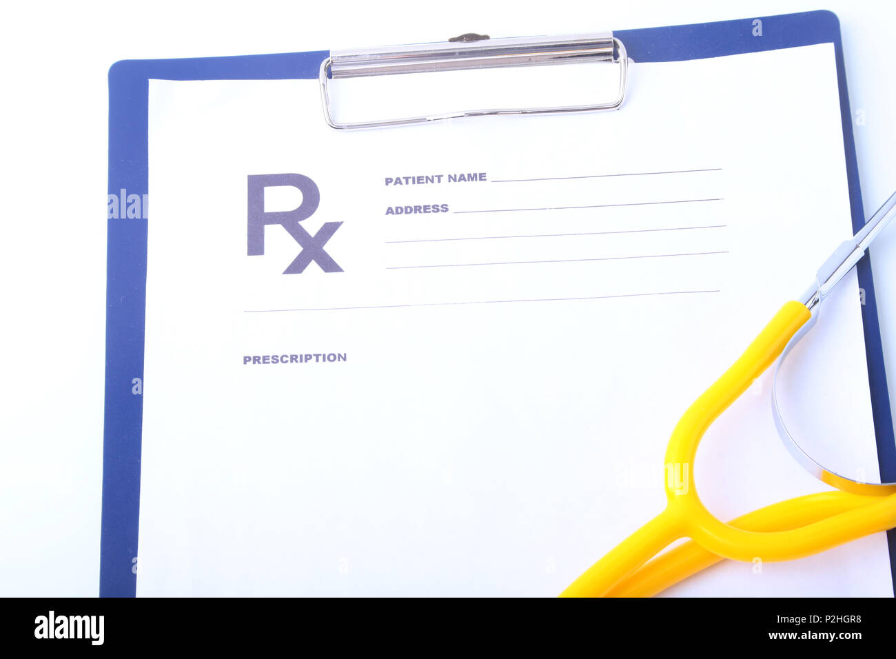 Closeup of medical stethoscope on a rx prescription, red heart isolated ...