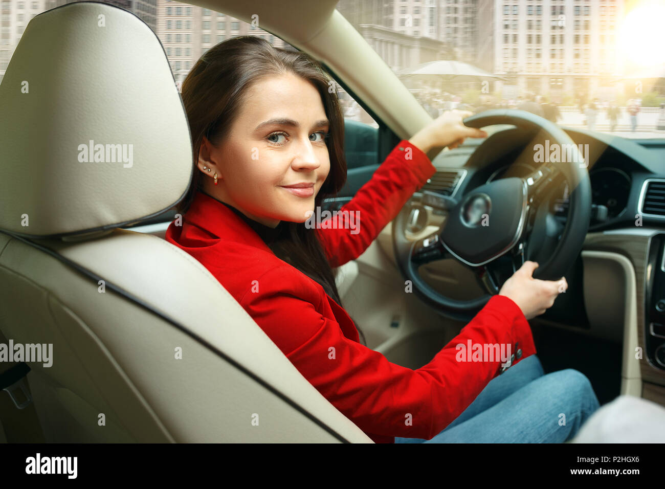 Driving around city. Young attractive woman driving a car Stock Photo ...