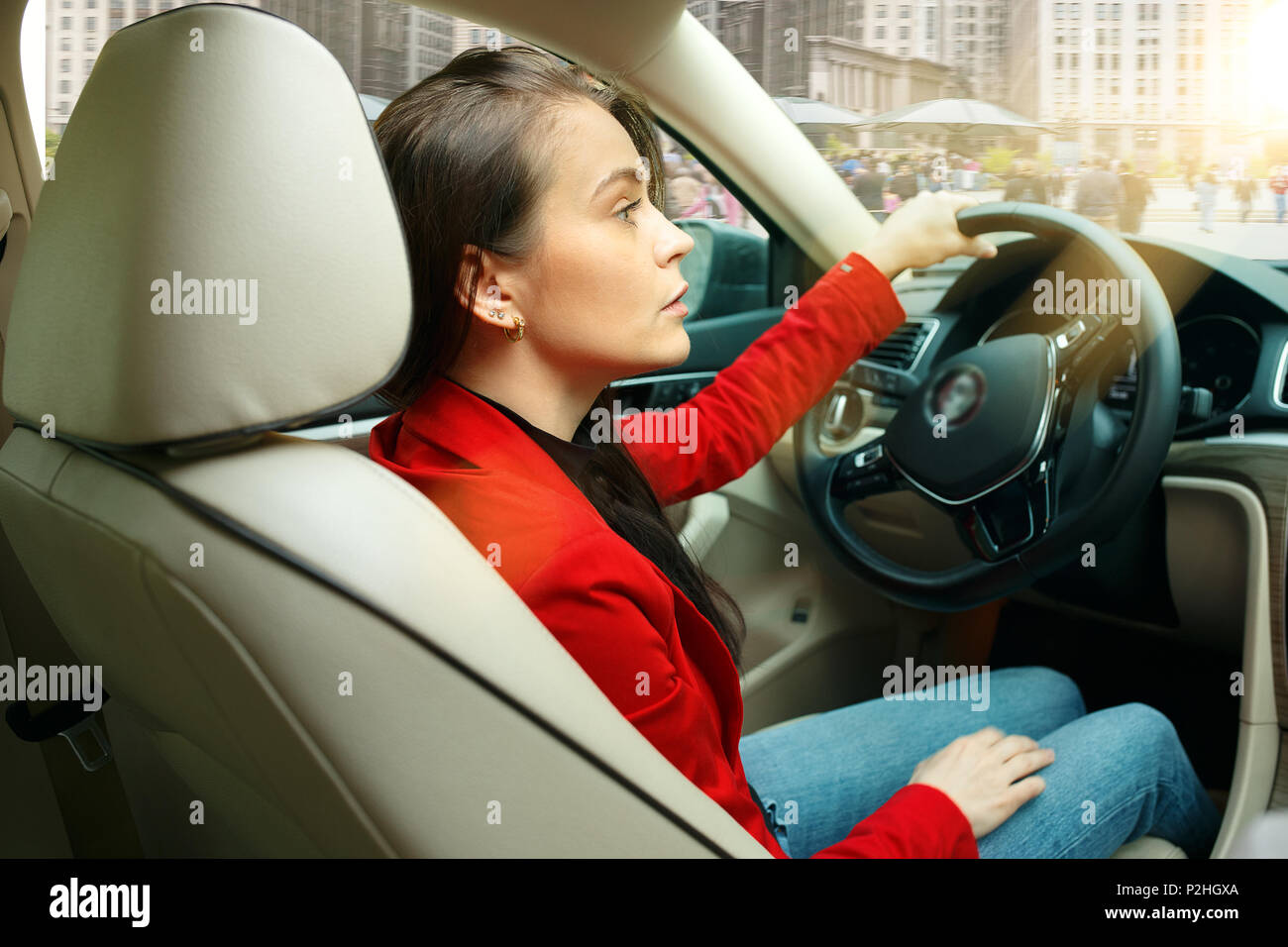 Driving around city. Young attractive woman driving a car Stock Photo ...