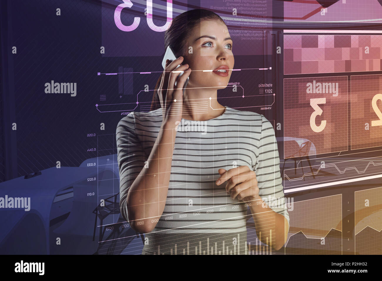 Calm young woman looking at the screen and having a phone talk Stock ...