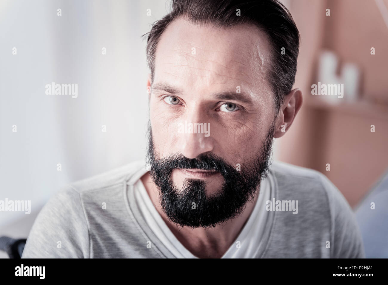 Concentrated man looking in the cam Stock Photo - Alamy