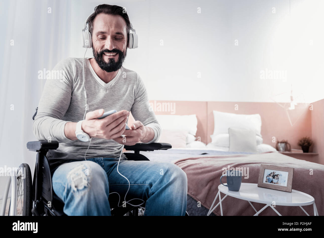 Happy disabled man listening to music Stock Photo - Alamy