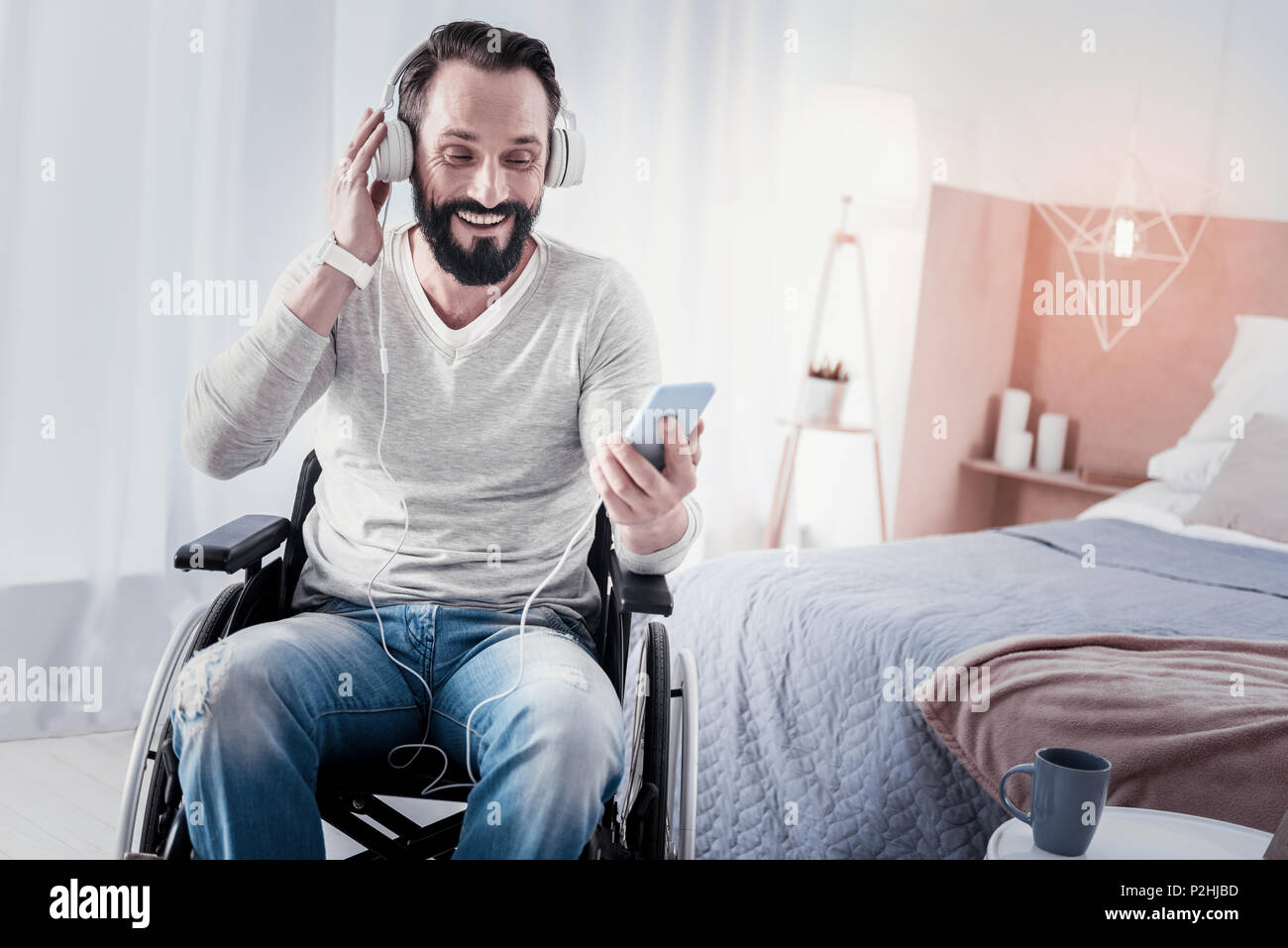 Joyful crippled man listening to music Stock Photo - Alamy