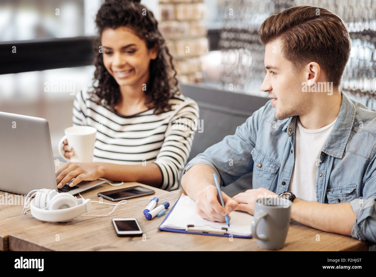 Nice young man taking notes Stock Photo - Alamy