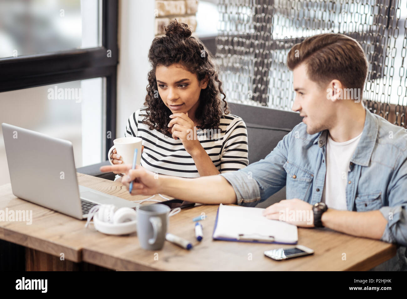 Joyful positive students discussing their project Stock Photo - Alamy