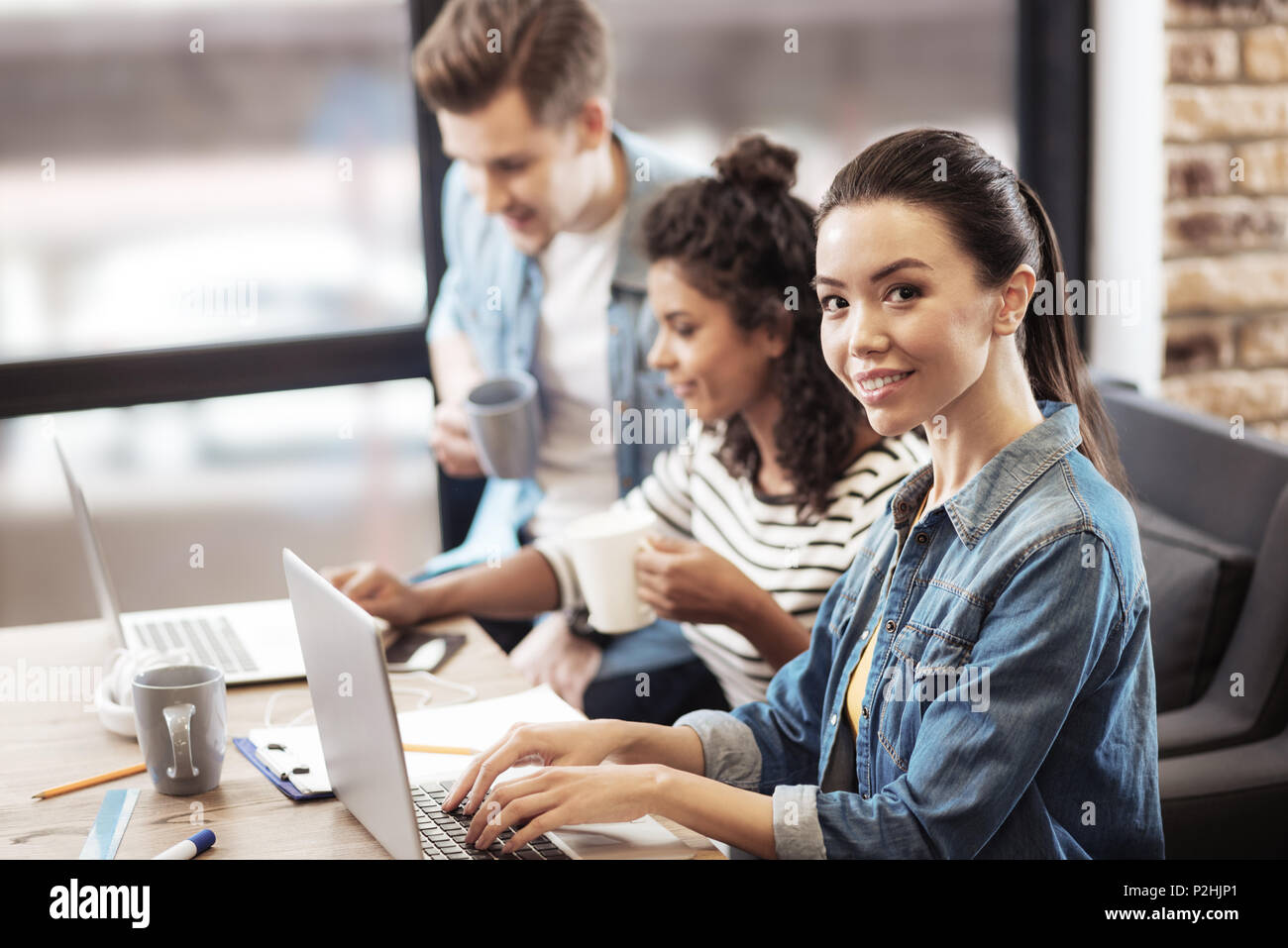 Smart young woman typing Stock Photo - Alamy