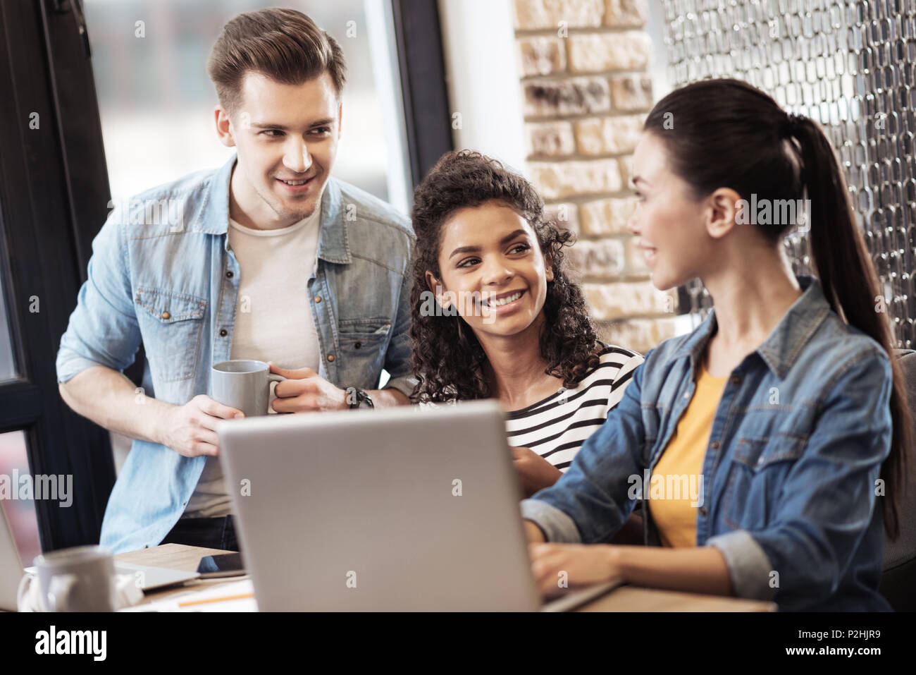 Positive nice students talking to each other Stock Photo - Alamy