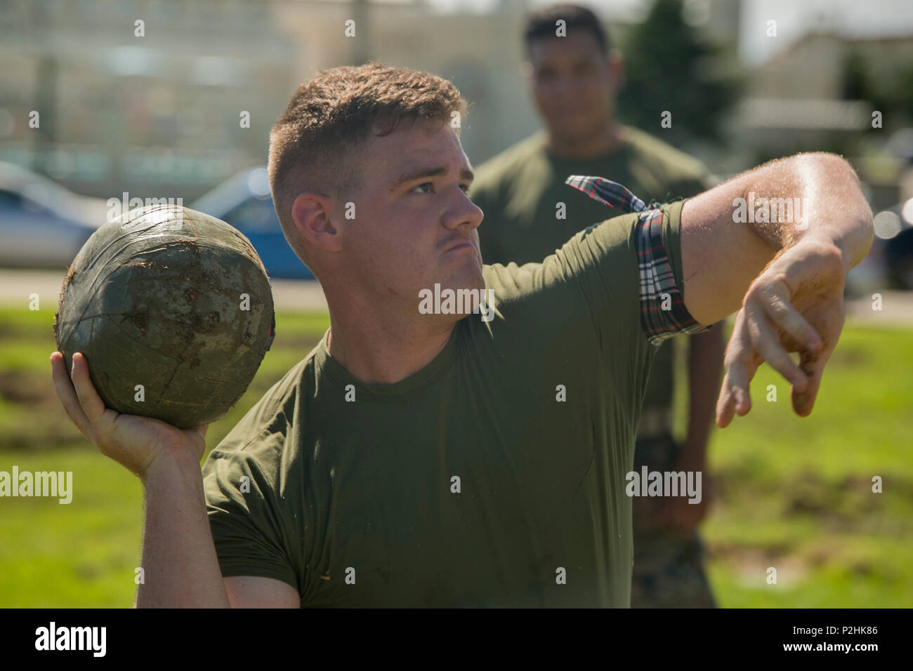 Cpl. Andrew Gunder throws an improvised stone during the Camp Hansen ...
