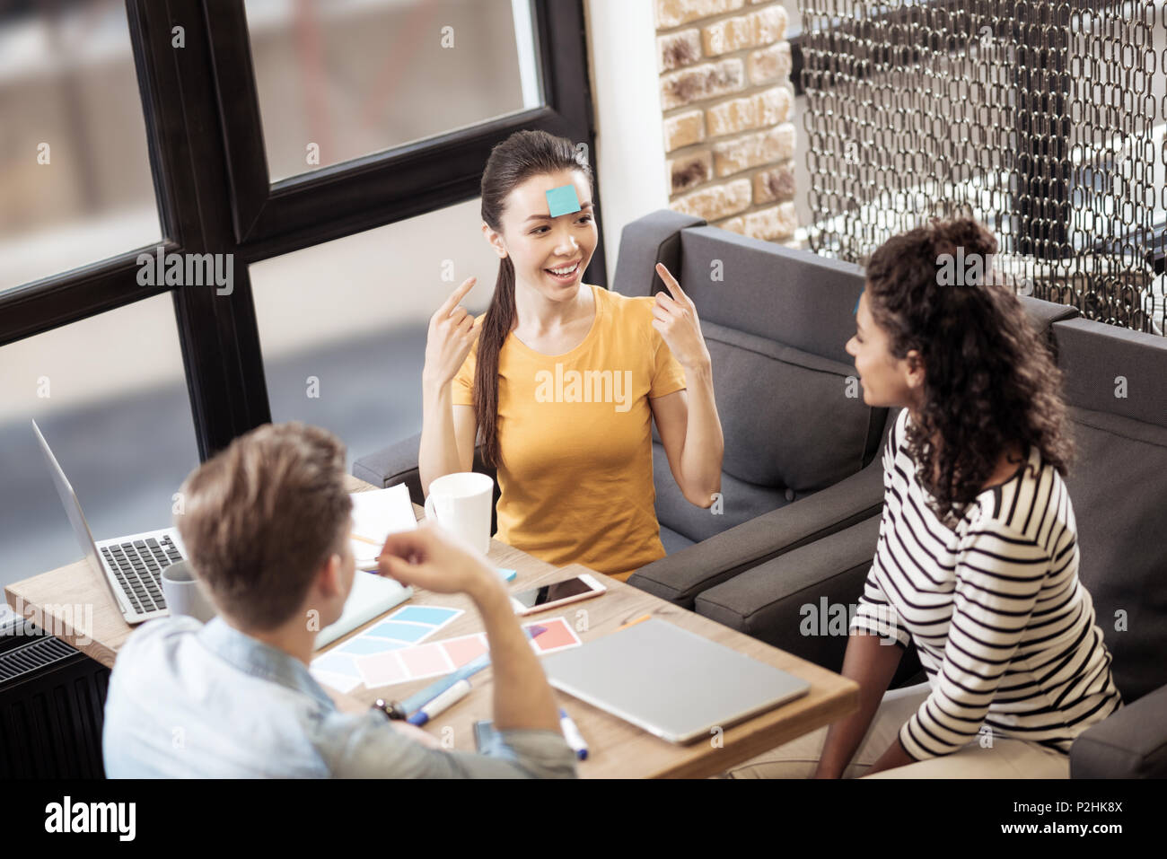 Delighted smart woman making a guess Stock Photo - Alamy